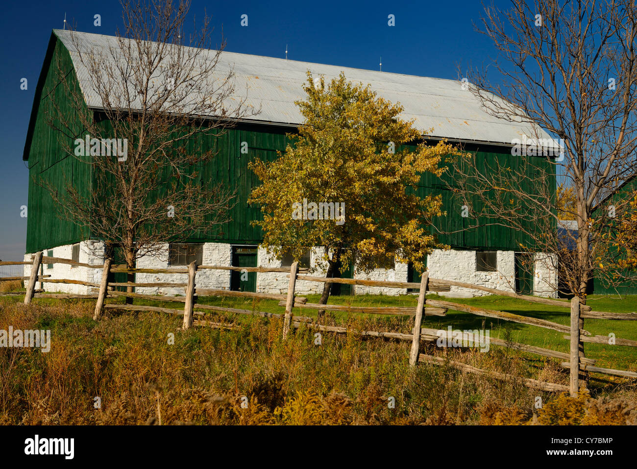 Working barn in the Fall near Toronto with fresh green paint and fence ...