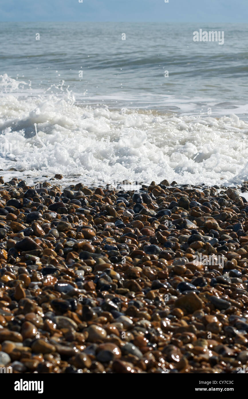 Breaking waves, swash, backwash and shingle on the beach at Pevensey ...