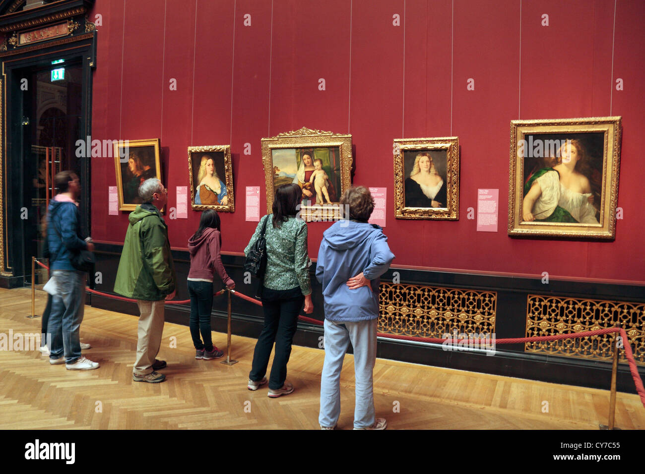 Visitors admiring a line of portraits in the Kunsthistorisches Museum ...