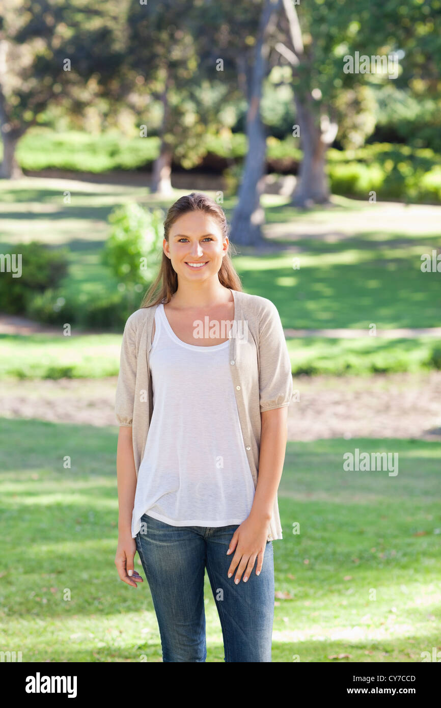 Smiling woman standing outside Stock Photo - Alamy