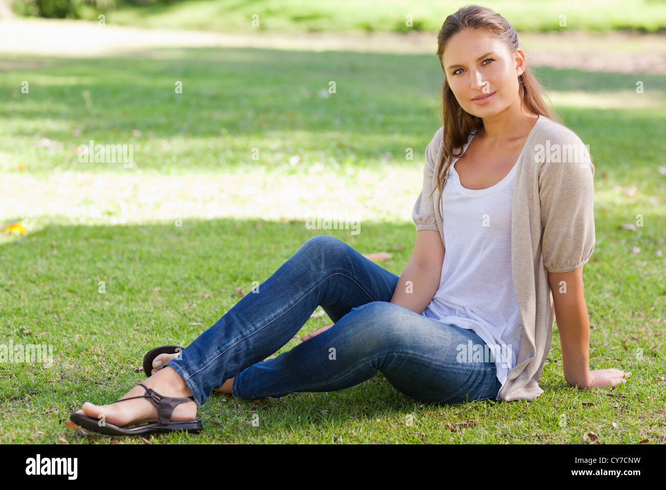 Woman sitting on the lawn Stock Photo - Alamy