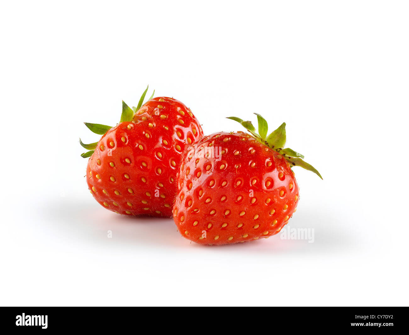 two strawberries on white table in white background Stock Photo - Alamy