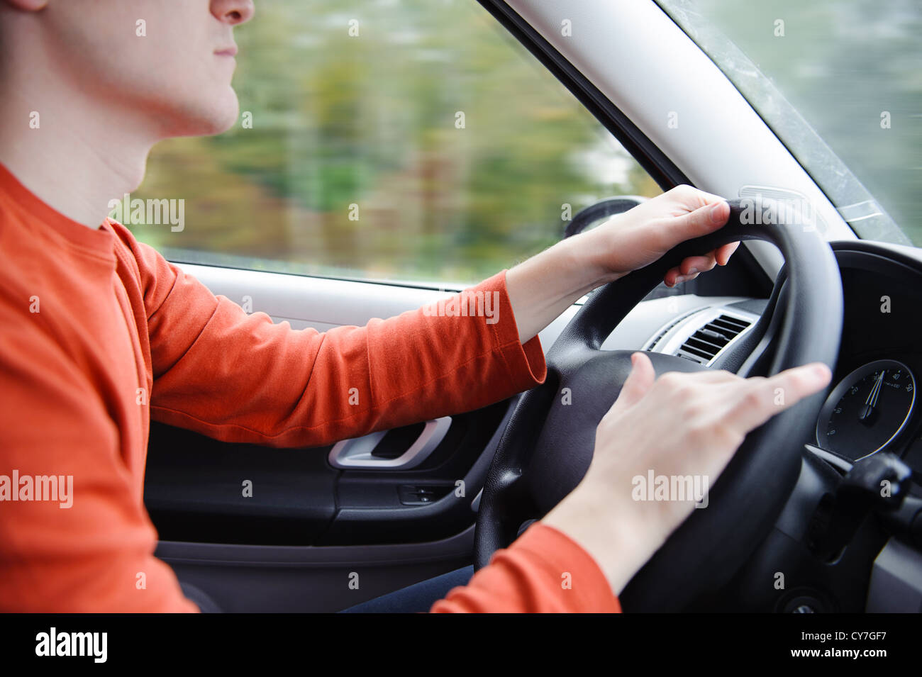 Young seriously man driving a car. Two hands on a steering wheel Stock ...