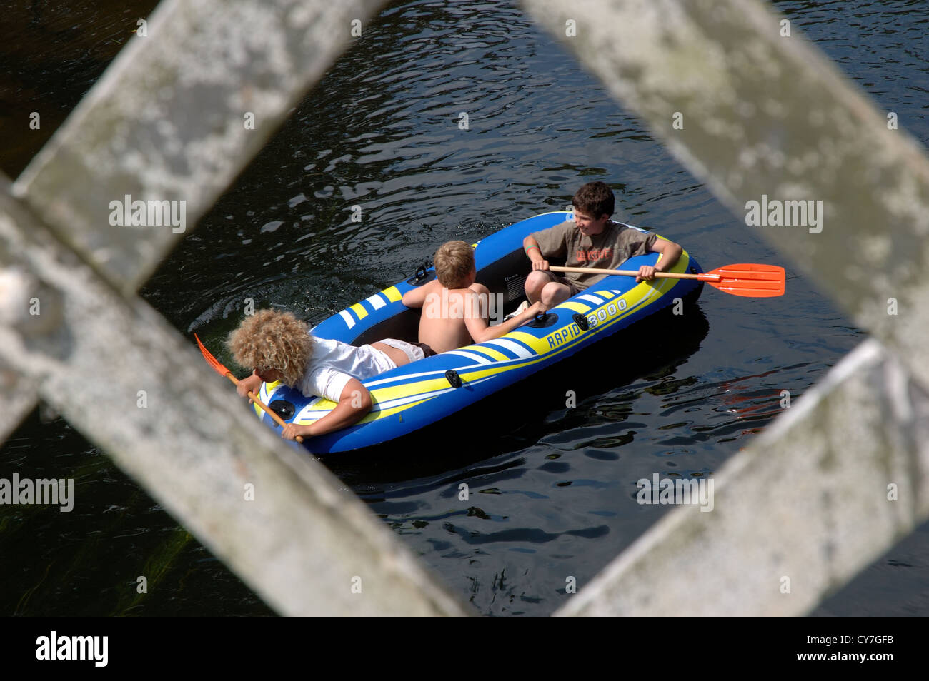 Children in an inflatable dinghy on the Little Ouse river at Santon ...