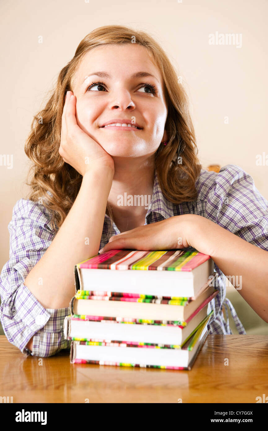 Attractive female student with books dreaming at university Stock Photo ...