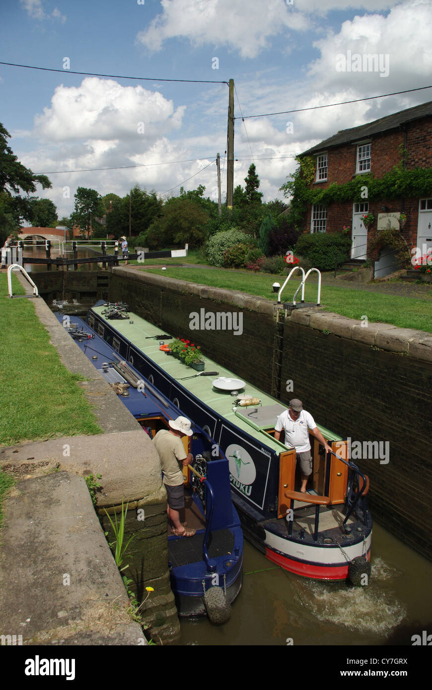 Two narrow boats entering a lock on the Grand Union Canal at Whilton ...