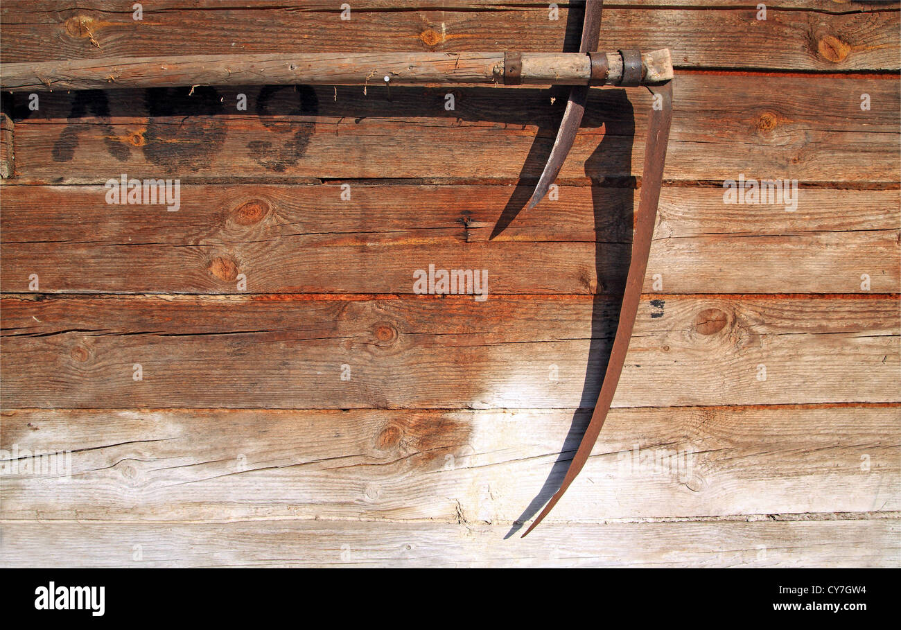 agricultural grunge background, scythe on wooden wall Stock Photo - Alamy