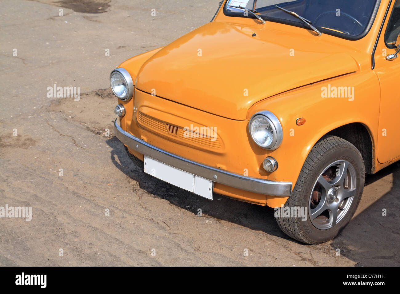 old orange car on town street Stock Photo - Alamy