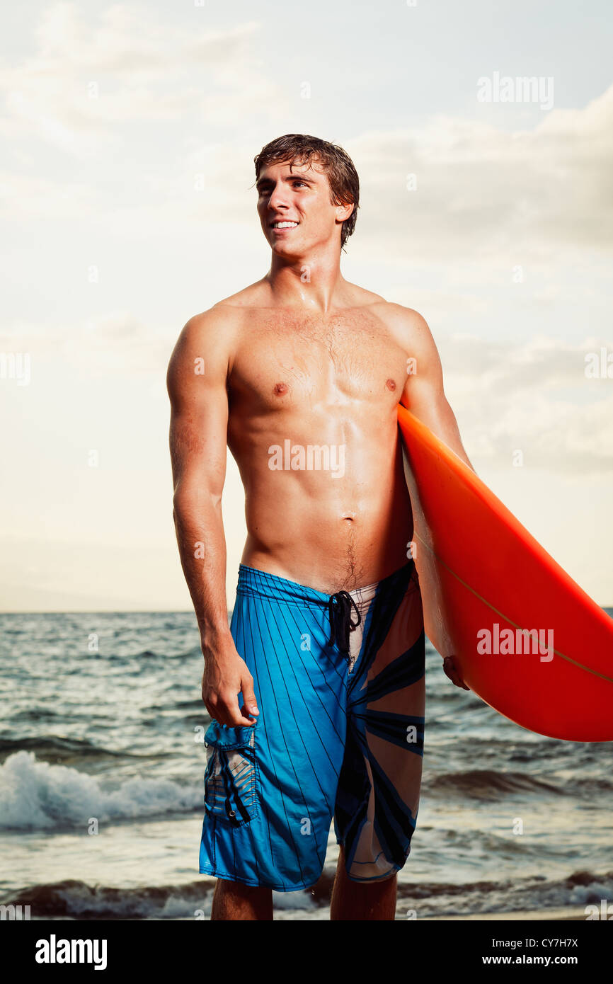 Professional Surfer holding a Surf Board Stock Photo - Alamy