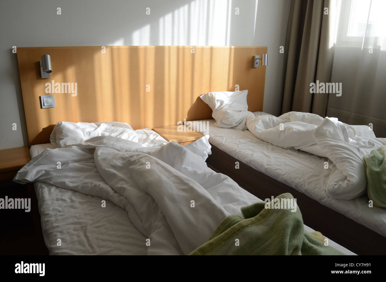 unfilled bed in motel room, pillow and blanket Stock Photo - Alamy