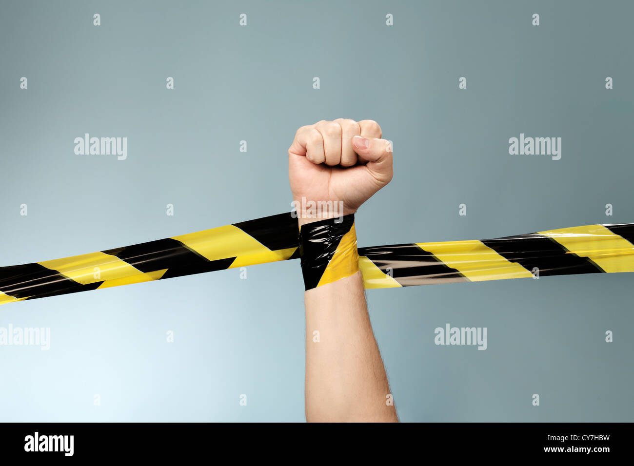 Hand tangled in black and yellow barrier tape Stock Photo - Alamy
