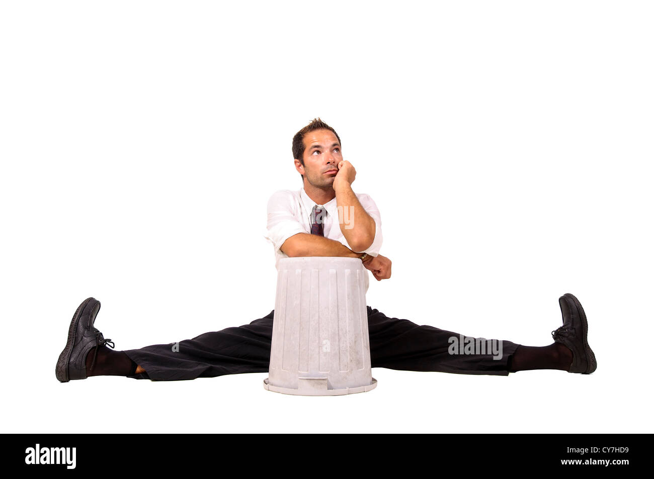 Businessman doing splits with office trash Stock Photo - Alamy