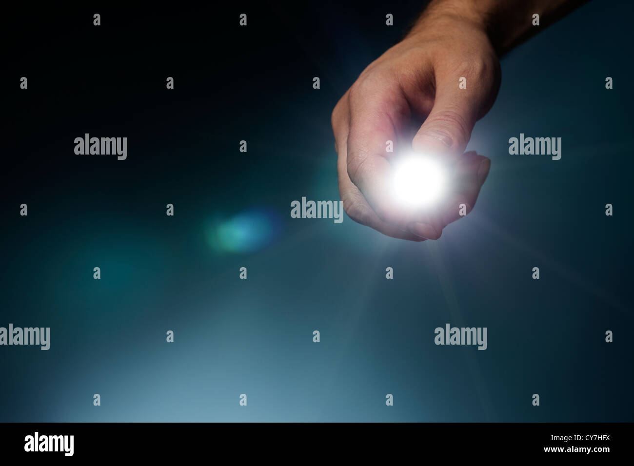 Man pointing a led flashlight towards camera Stock Photo - Alamy