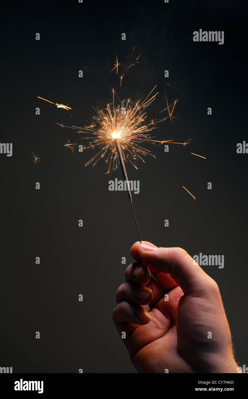 Sparkler burning sparks in hand hi-res stock photography and images - Alamy