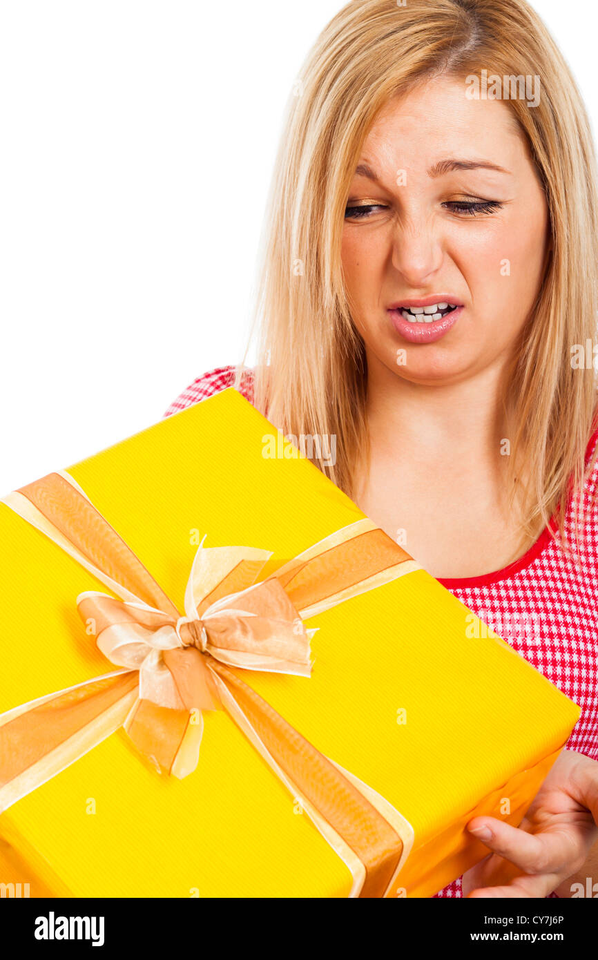Close up of a young disappointed woman holding yellow gift box ...