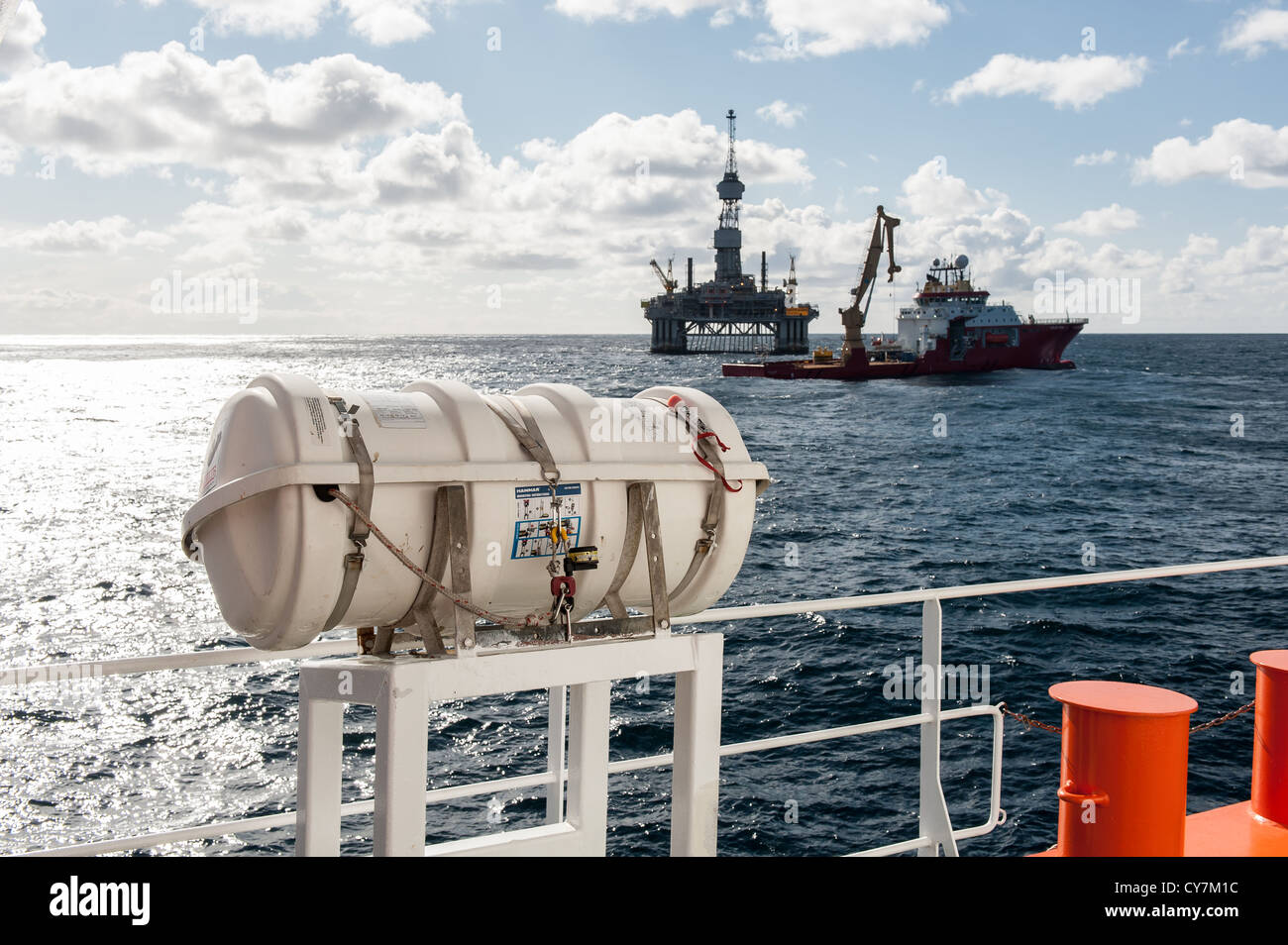 Live raft with oil rig and supply boat in the background on the North ...