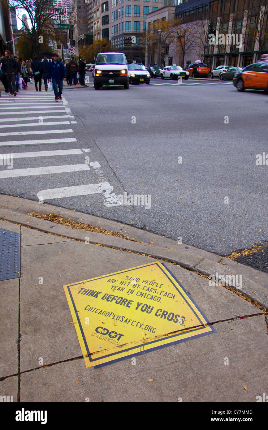 Pedestrian warning painted on sidewalk at crosswalk. Michigan Avenue ...