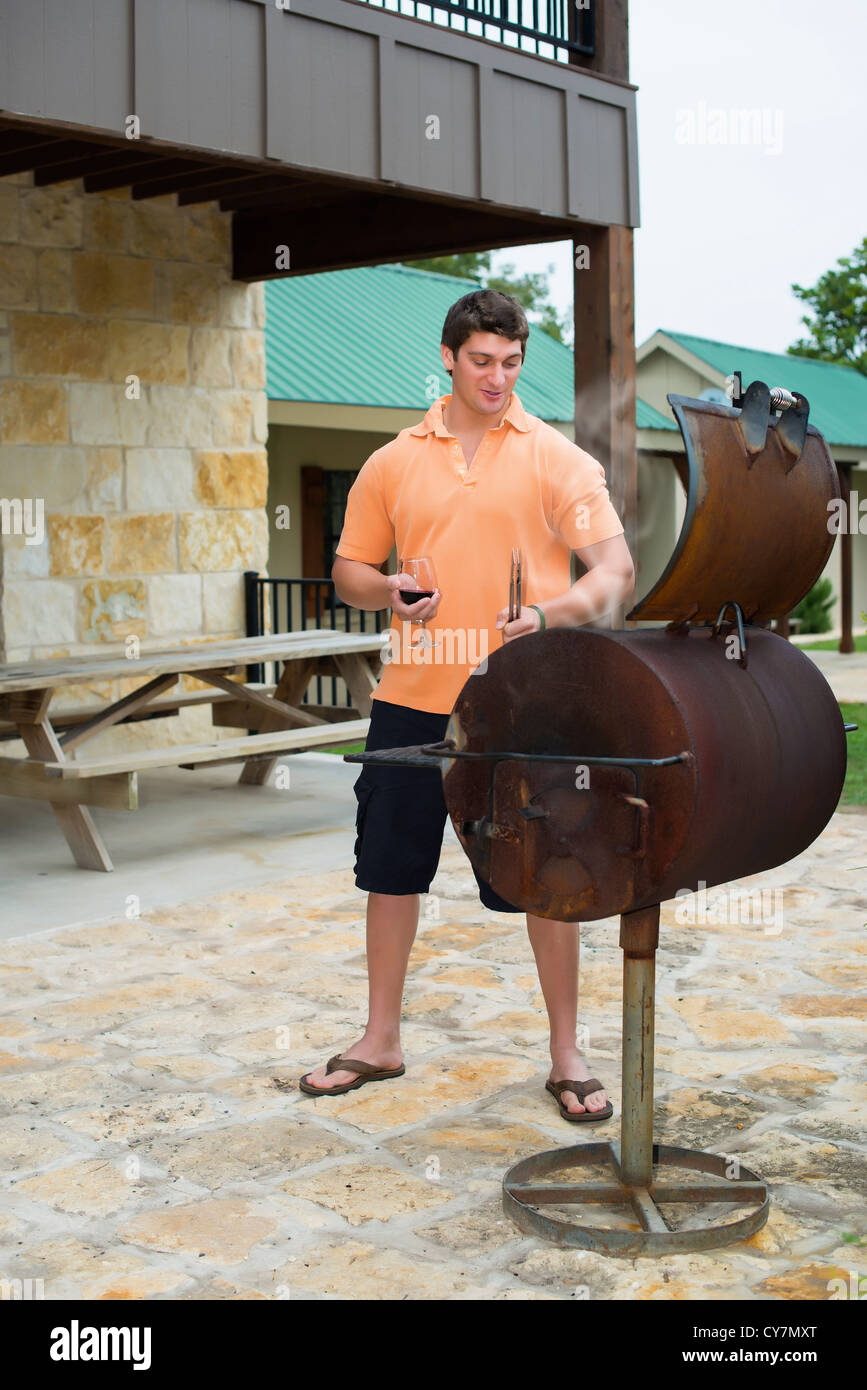 Young men enjoying a barbeque hi-res stock photography and images - Alamy