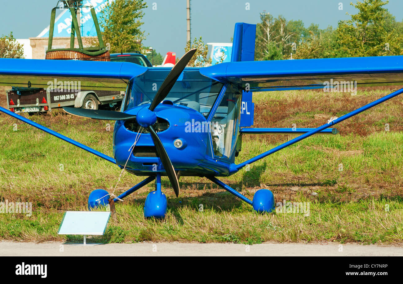Light airplane for cruising and training on blue colour - front view ...