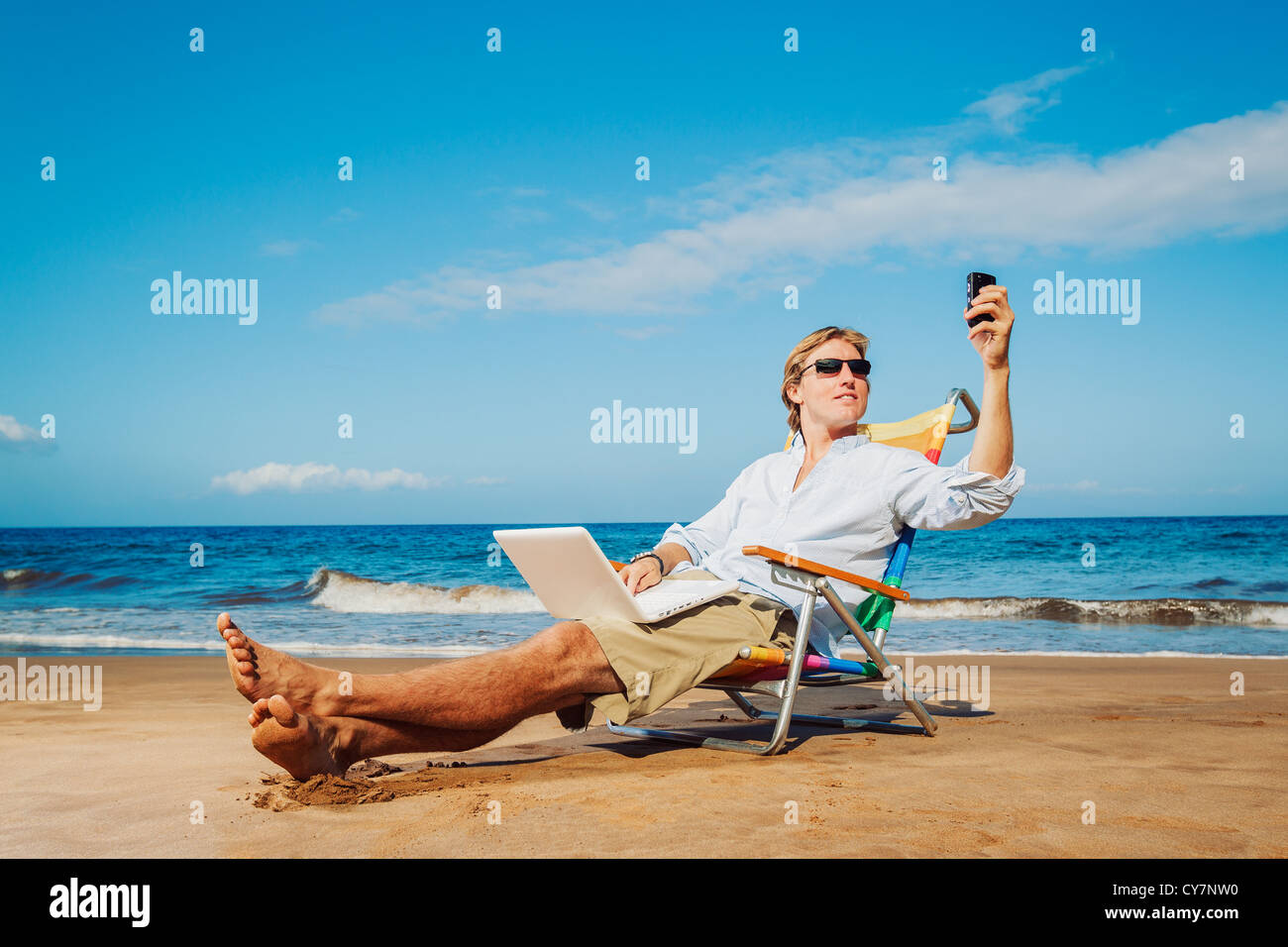 Young Business Man Working Remotely on Tropical Beach Stock Photo - Alamy