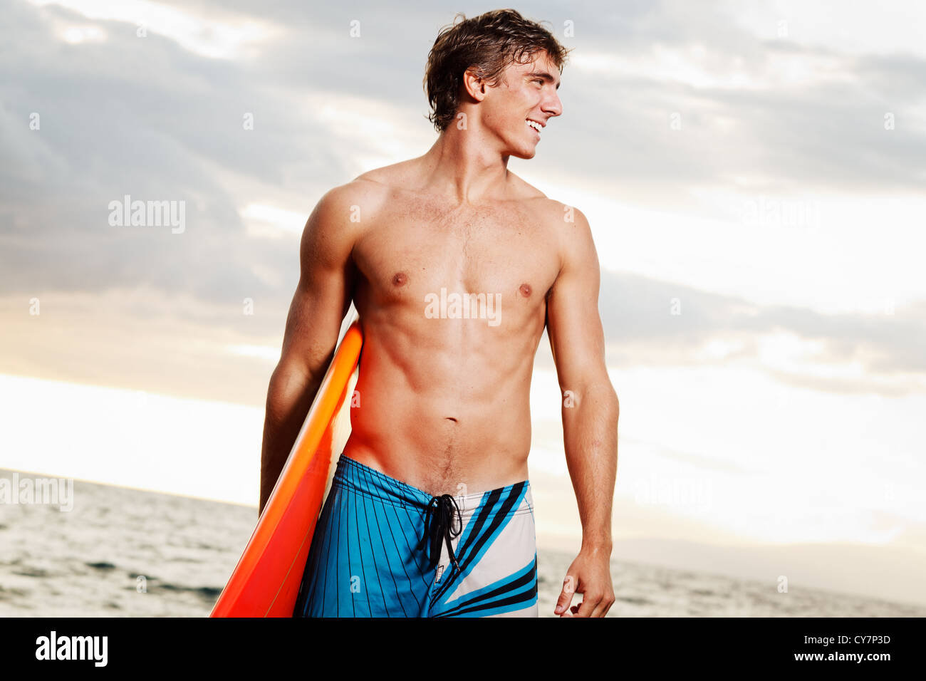 Professional Surfer holding a Surf Board Stock Photo - Alamy