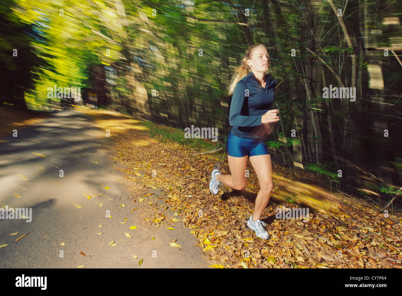 Woman Running Outdoors with Motion Blur Stock Photo - Alamy