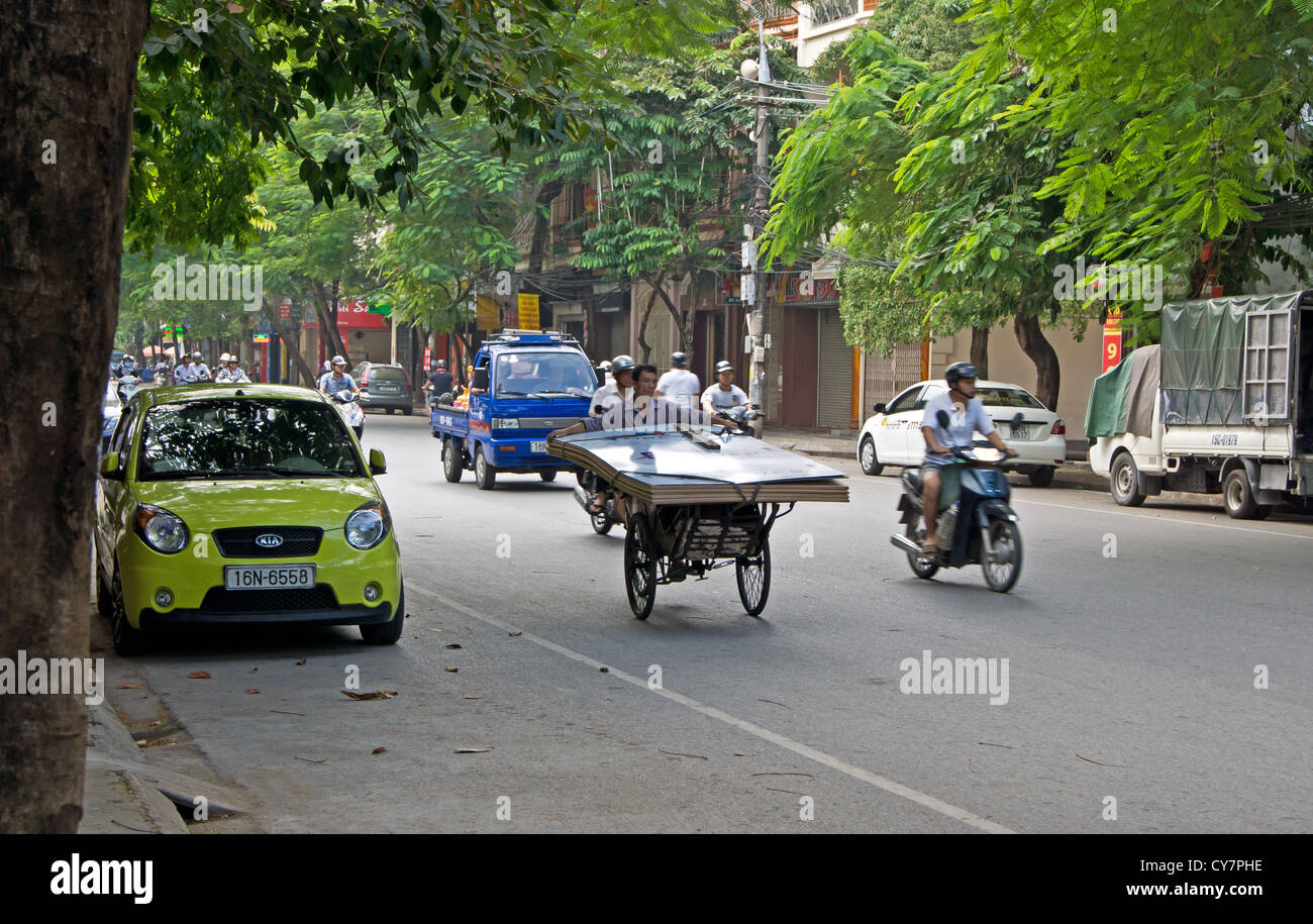A Vietnamese man carrying sheets of wood on his bike cart in Hai Phong ...