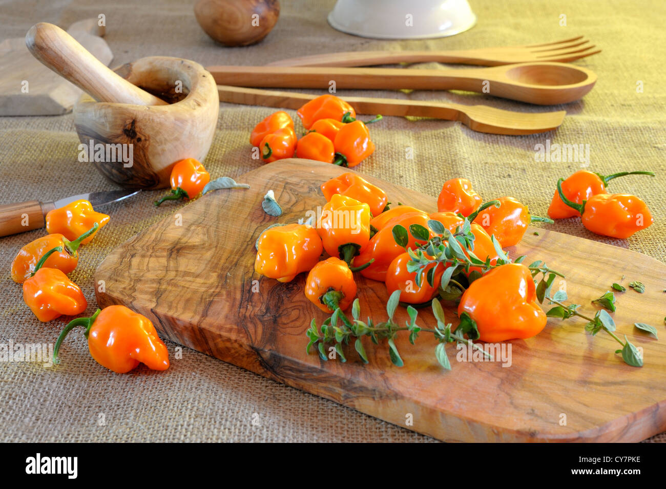 Beautiful and colored chili peppers on a wooden base Stock Photo - Alamy