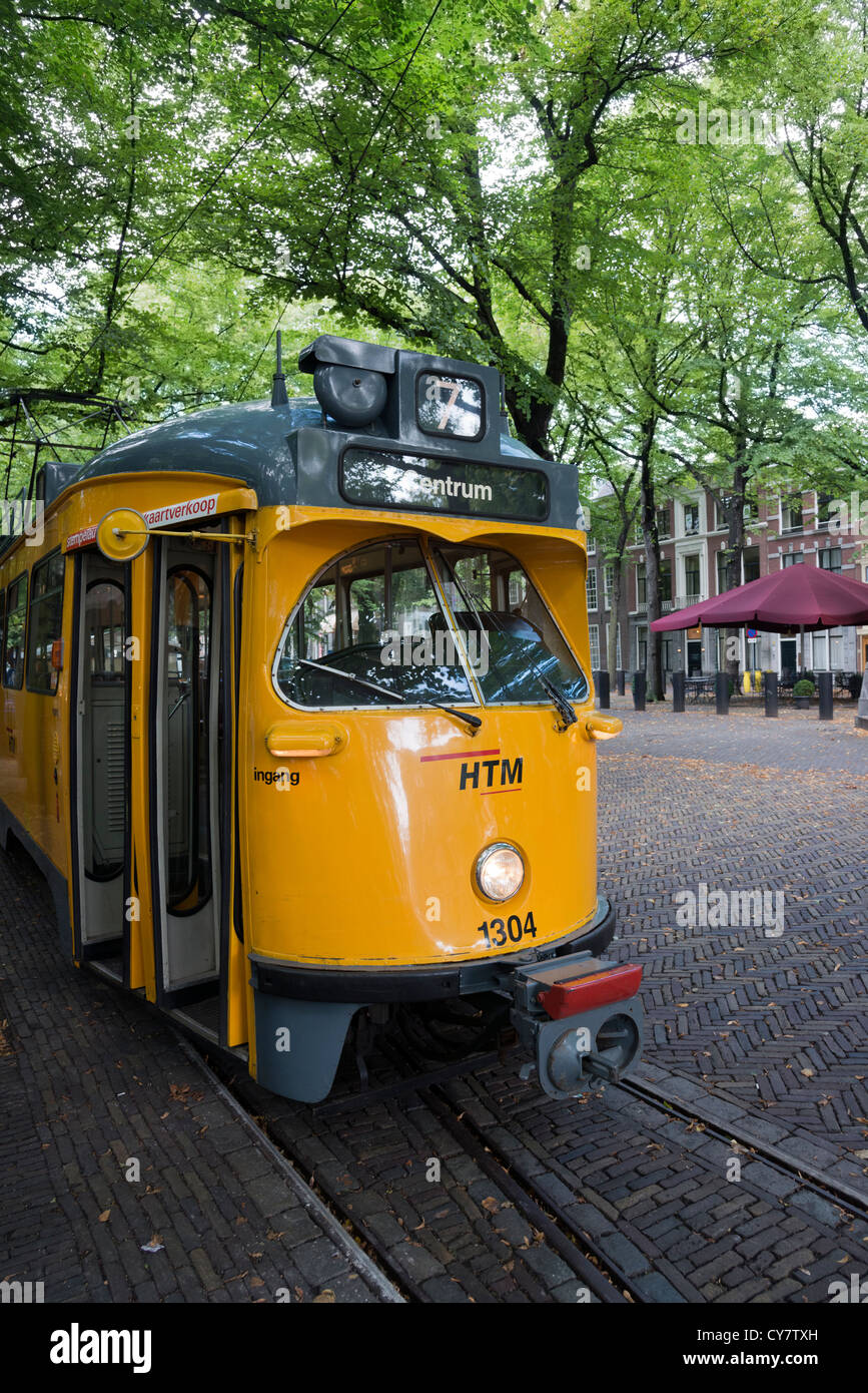 A traditional city centre Dutch yellow tram at Lange Voorhout in the ...