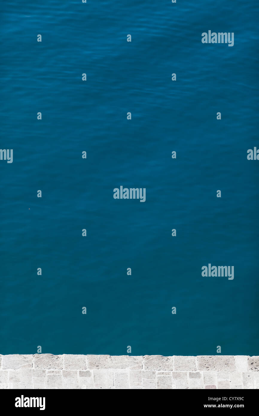 Blue sea stone dock background hi-res stock photography and images - Alamy