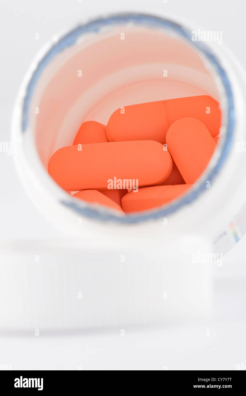 Orange capsules isolated on white Stock Photo - Alamy