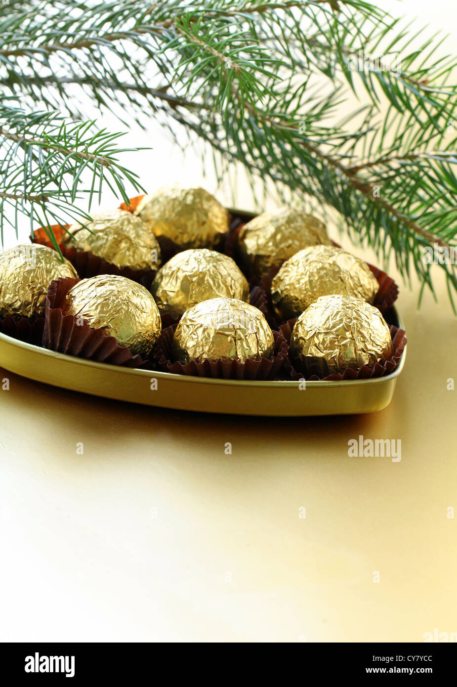 chocolate truffles in a gift box under the Christmas tree Stock Photo ...