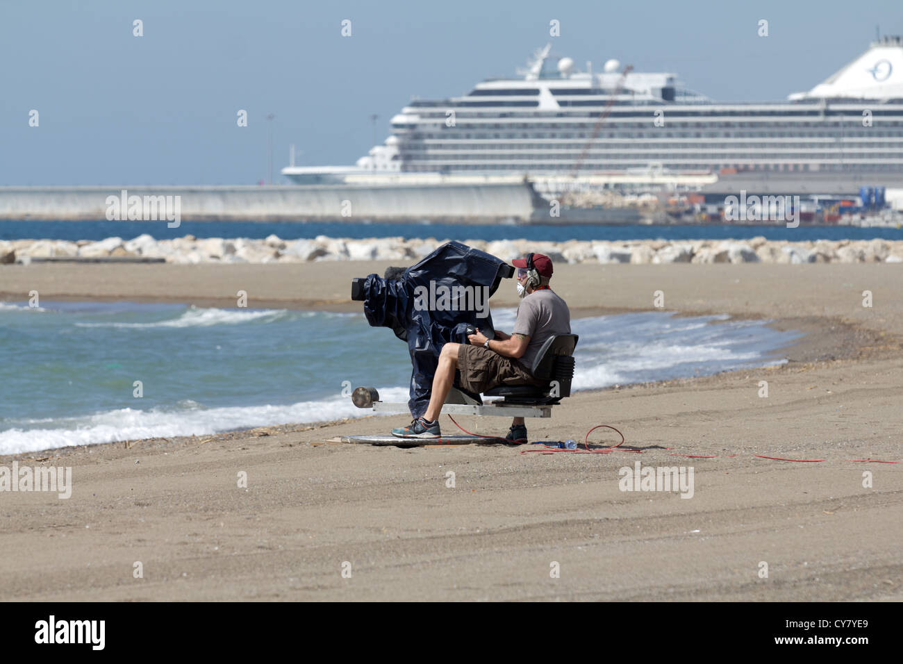 Cameraman filming at the beach Stock Photo - Alamy