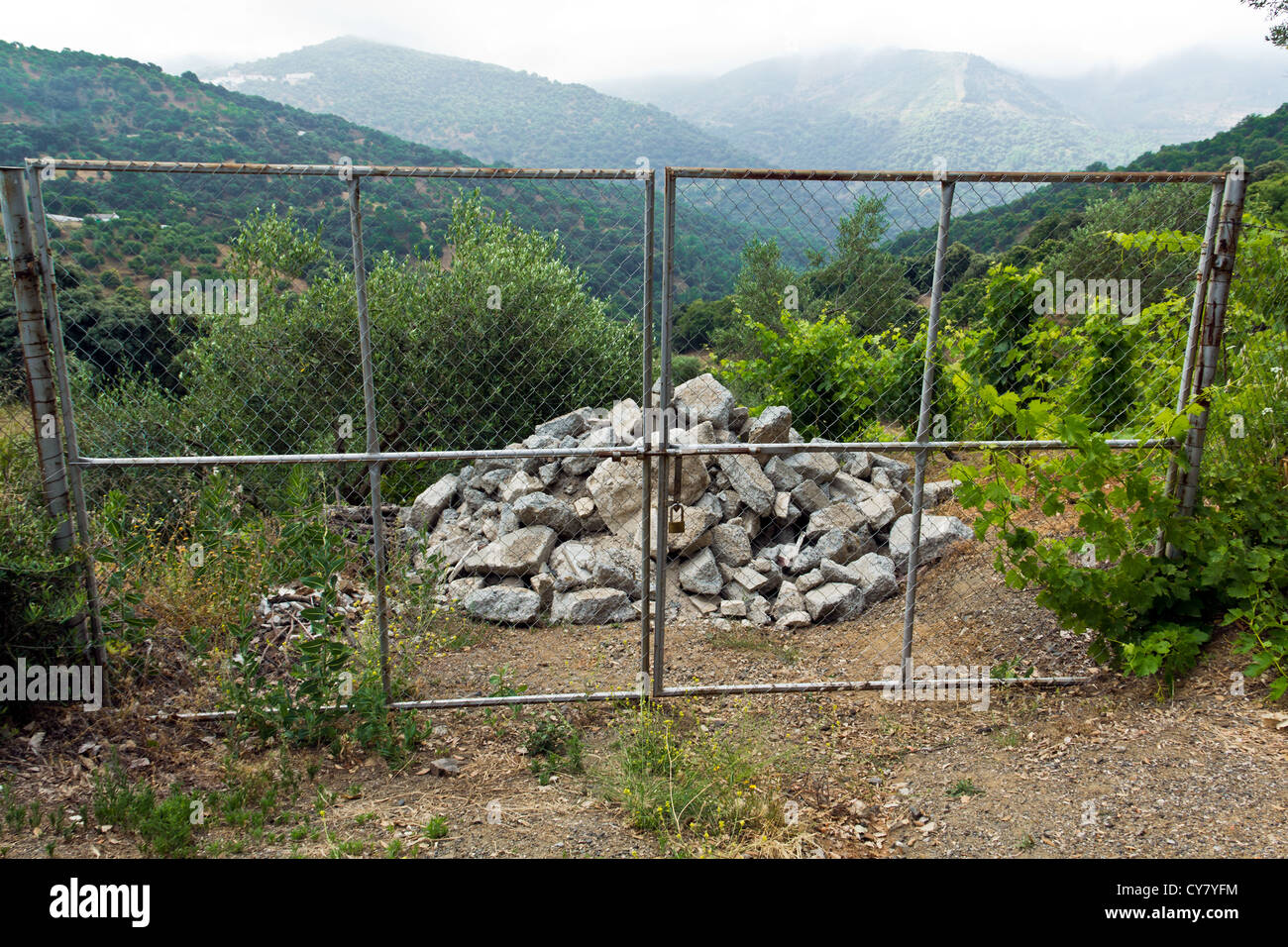 Rocks piled behind a metallic fence Stock Photo - Alamy