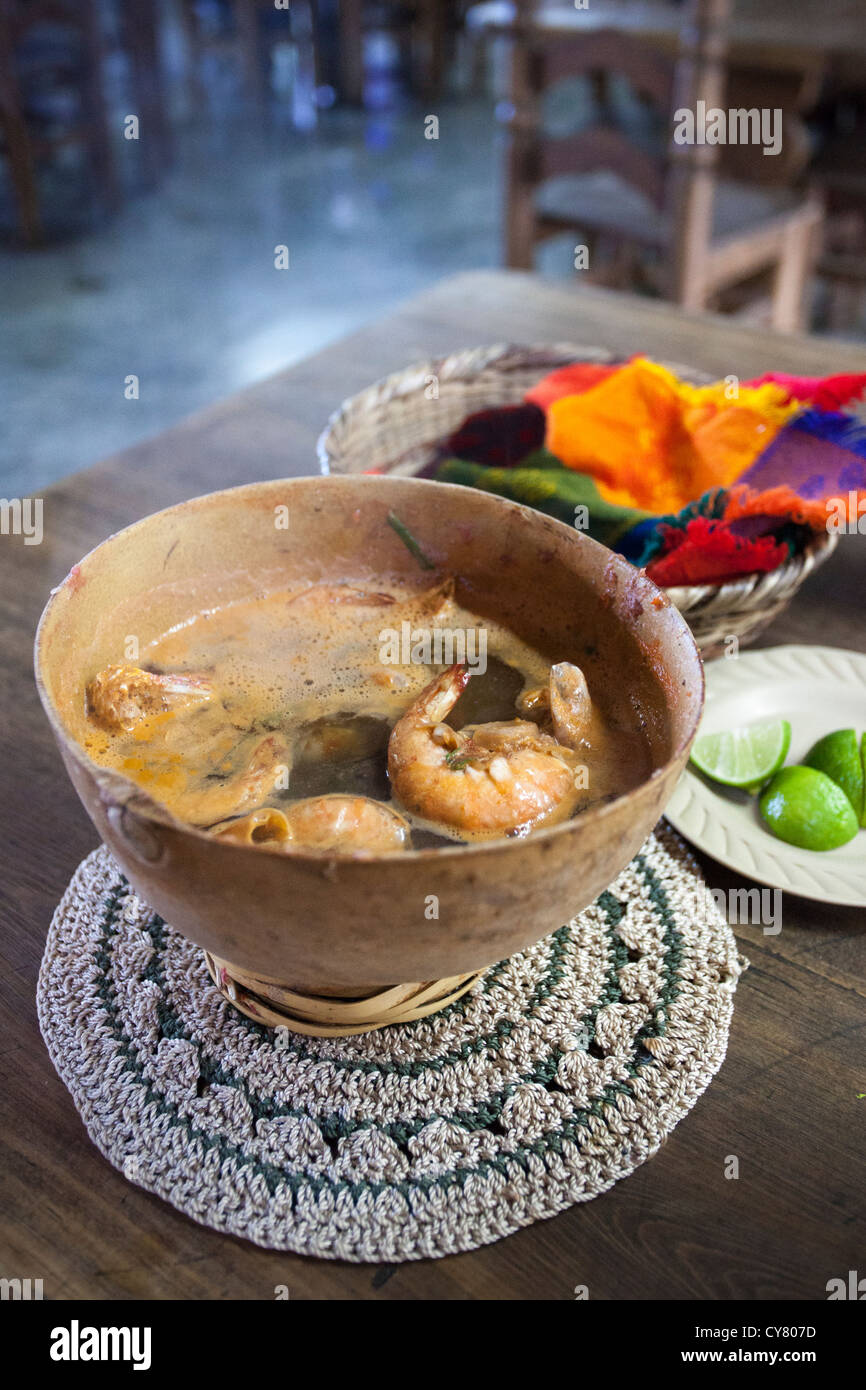 A bowl of "stone soup", a seafood broth which uses rocks to cook the ...