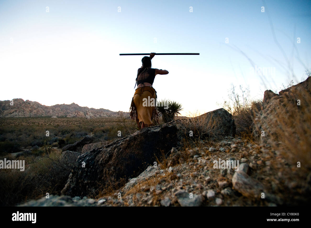 Natural woman in the desert dancing with her danda staff Stock Photo ...