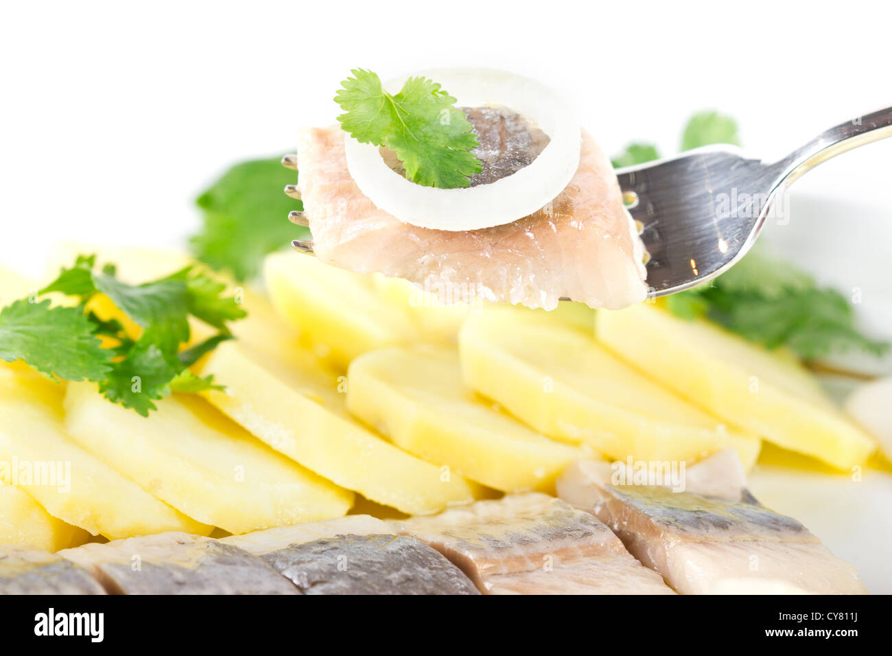 Portion of herring fish fillets with potato and onion Stock Photo - Alamy