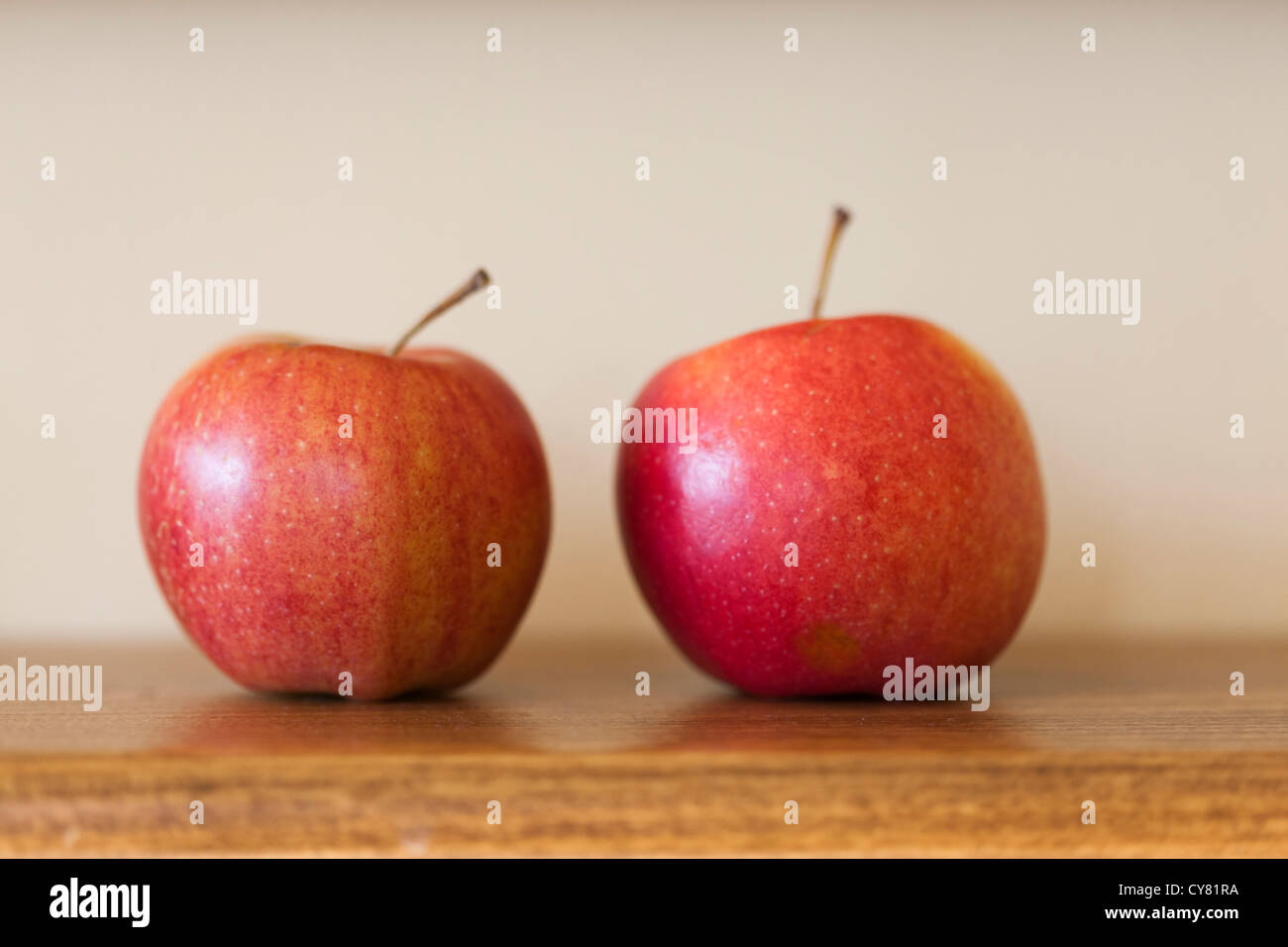 Two Red Apples on Shelf Stock Photo - Alamy