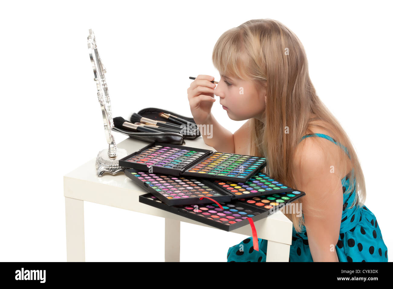 Little girl paints his face makeup, on white background Stock Photo - Alamy