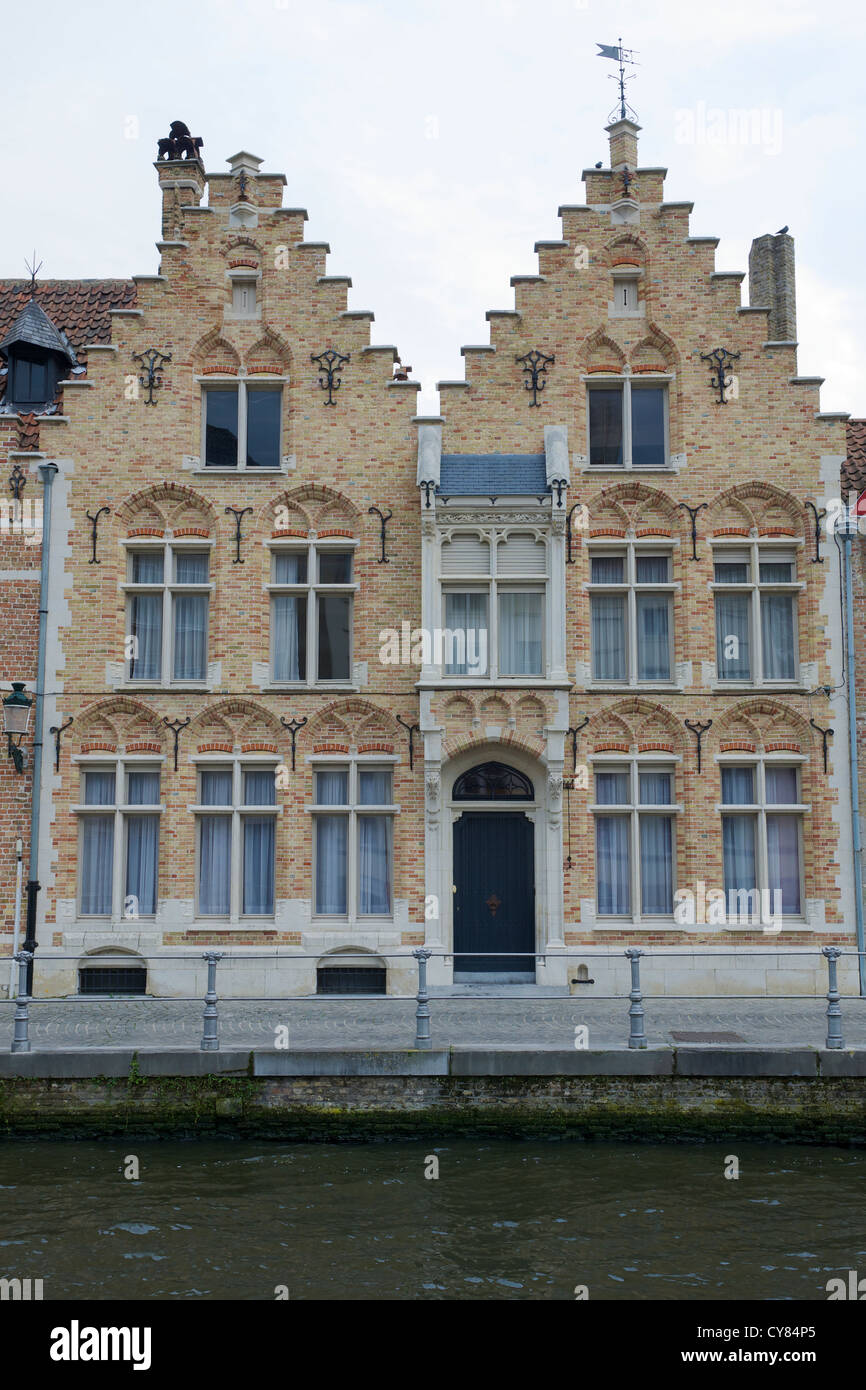The facade of a traditional canal-side home in Brugge, Belgium Stock ...