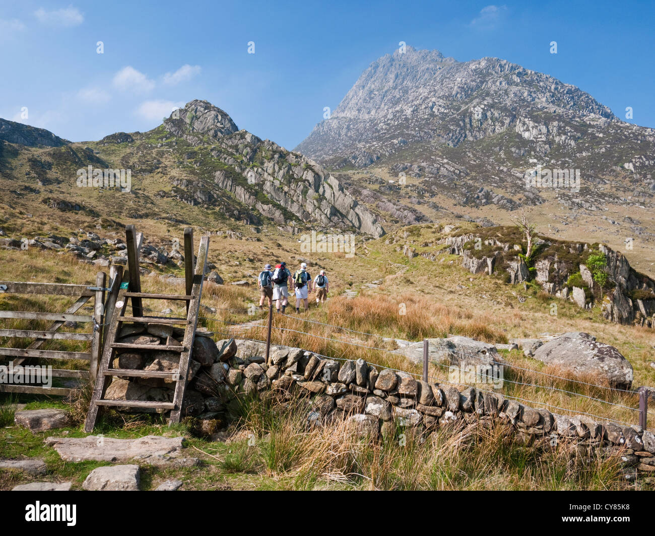 Hill walkers enroute for the mountain of Tryfan pass below the smaller ...