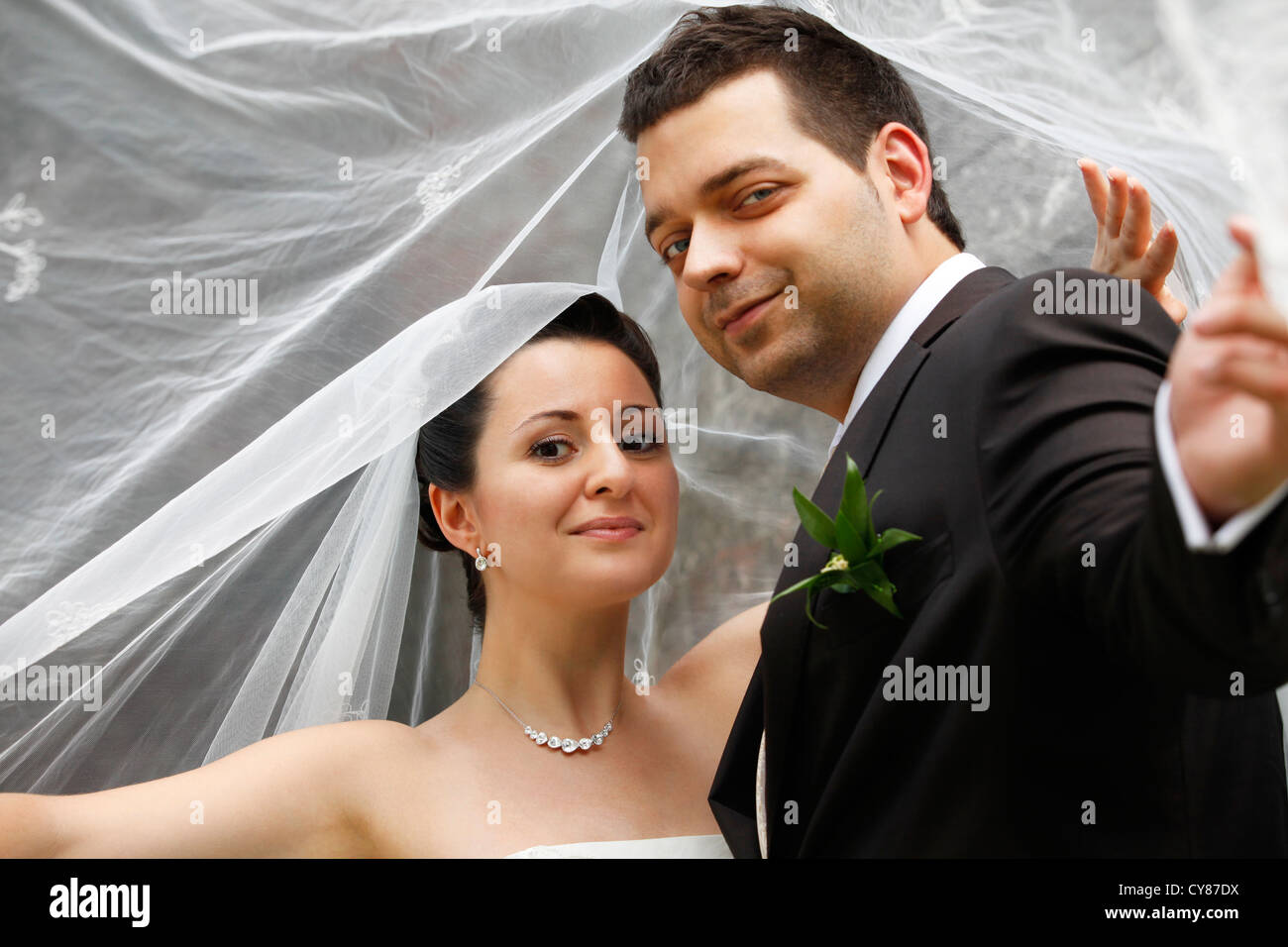 Newly-married couple in wedding clothes in park Stock Photo - Alamy