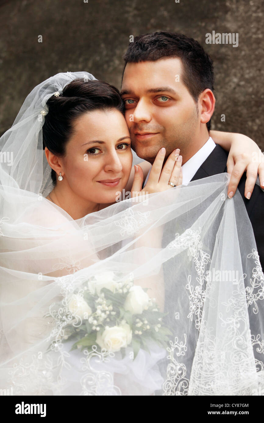 Newly-married couple in wedding clothes in park Stock Photo - Alamy