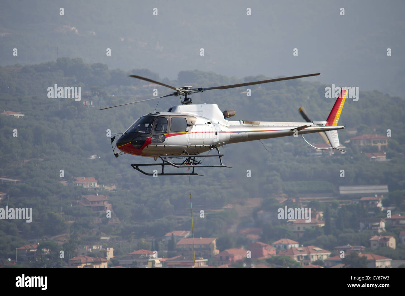 Helicopter flying up high above town or city Stock Photo - Alamy