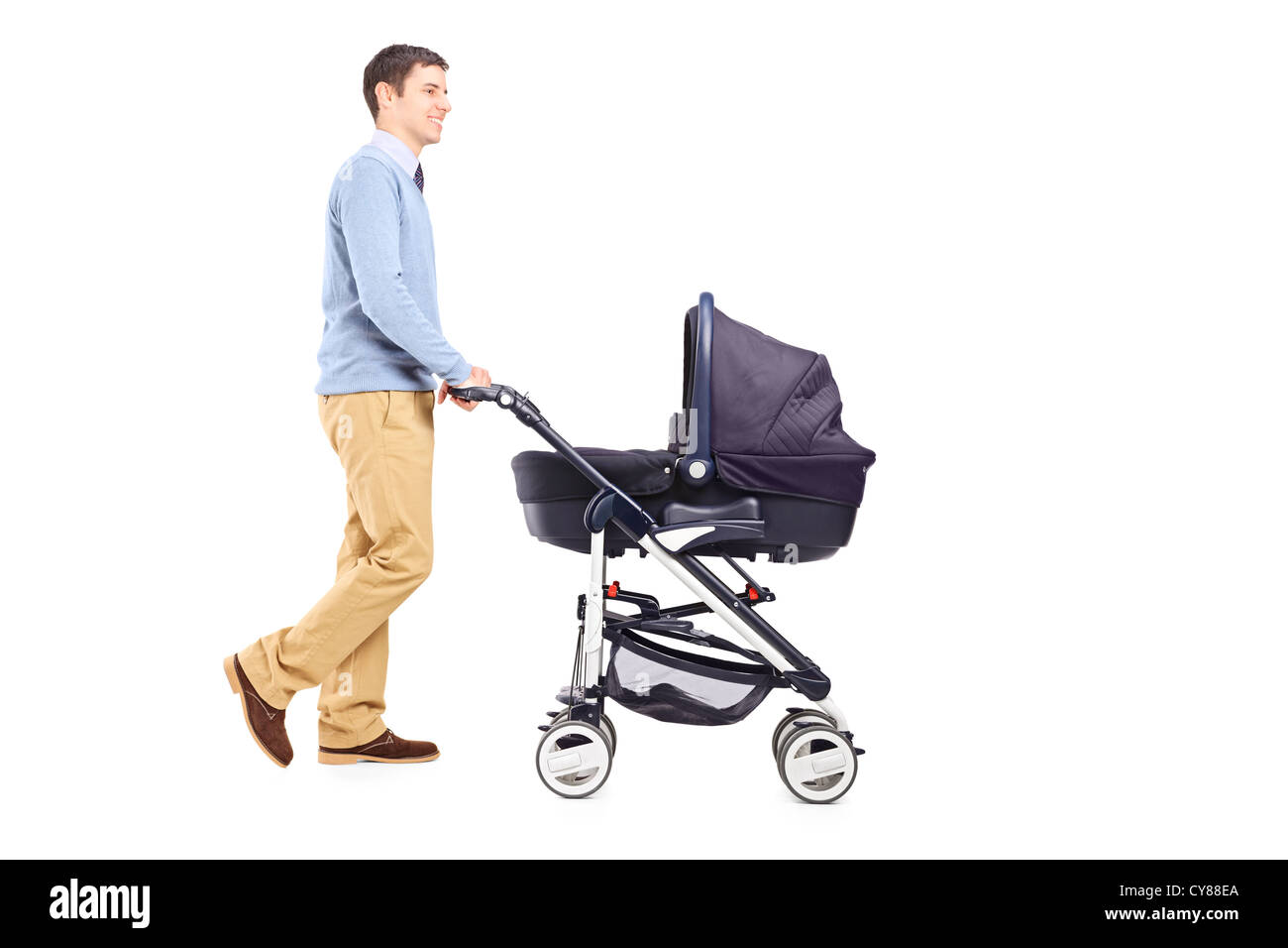 Full length portrait of a father pushing a baby stroller isolated on ...