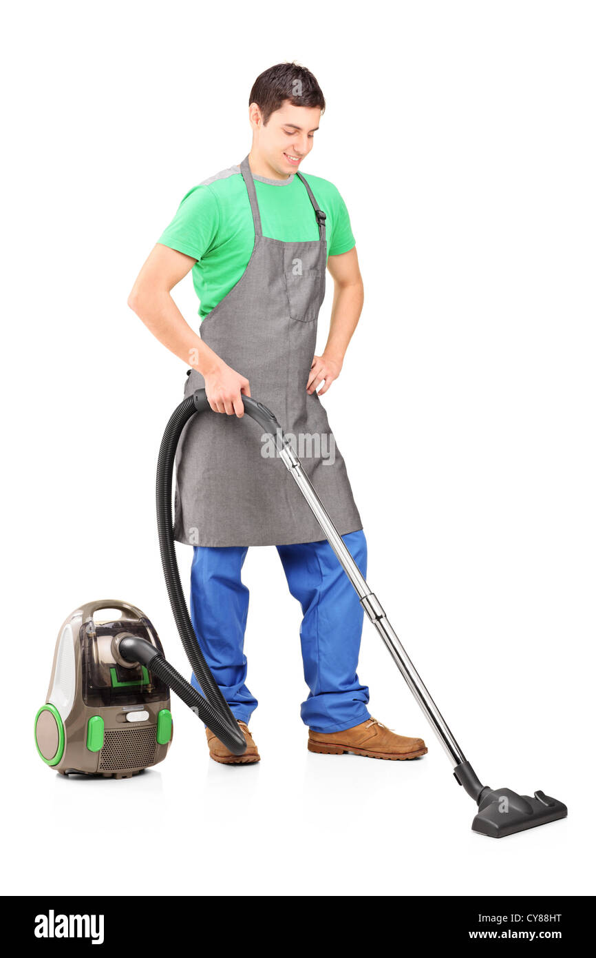 Full length portrait of a man cleaning with vacuum cleaner isolated ...