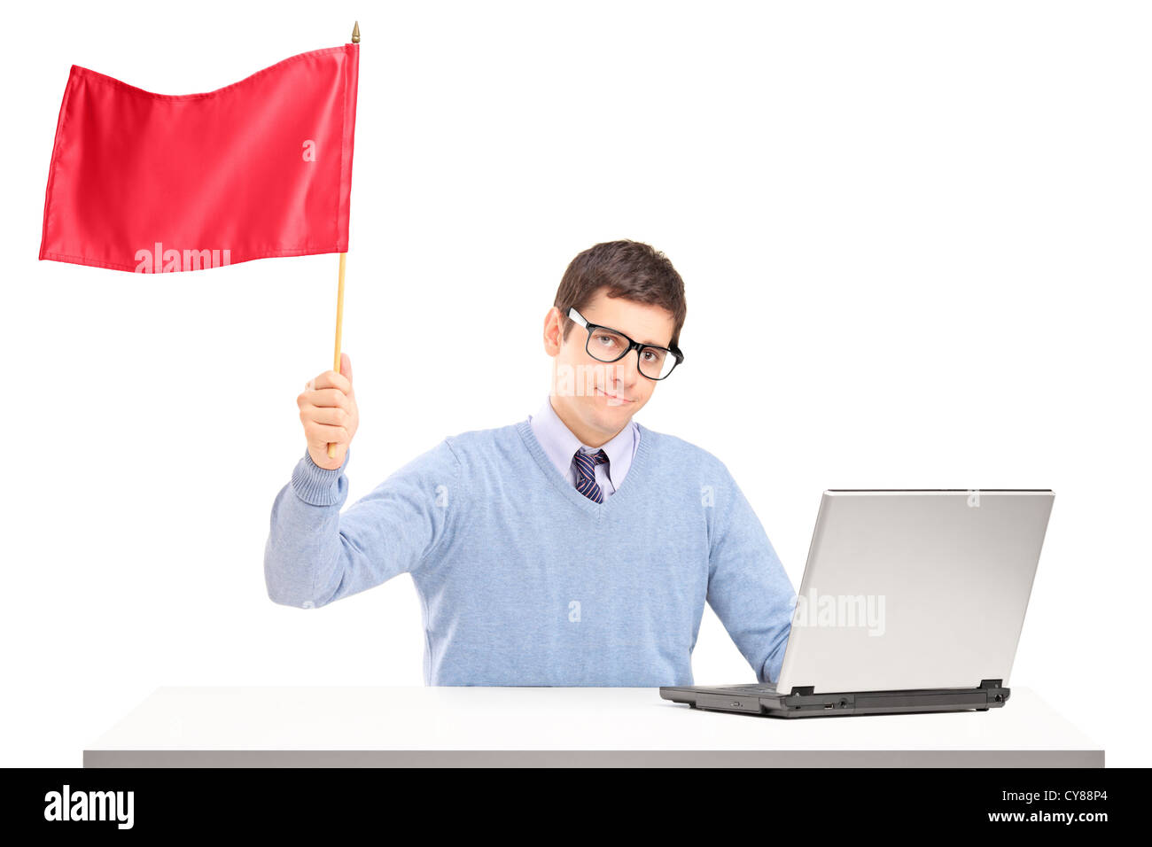 Sad man sitting with laptop and waving a red flag isolated on white ...