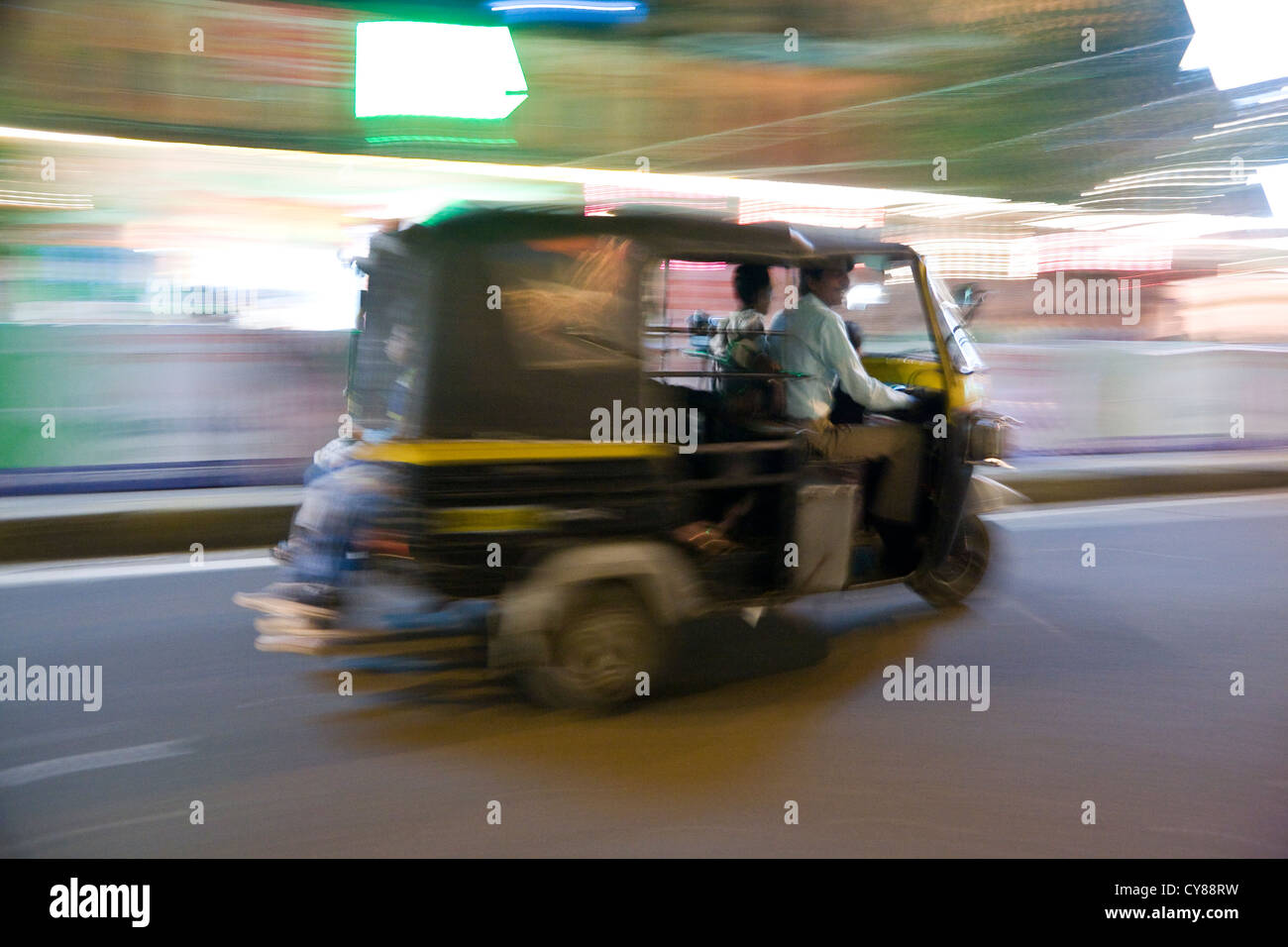 Men in an auto rickshaw celebrating Diwali at a bazaar in Jaipur ...