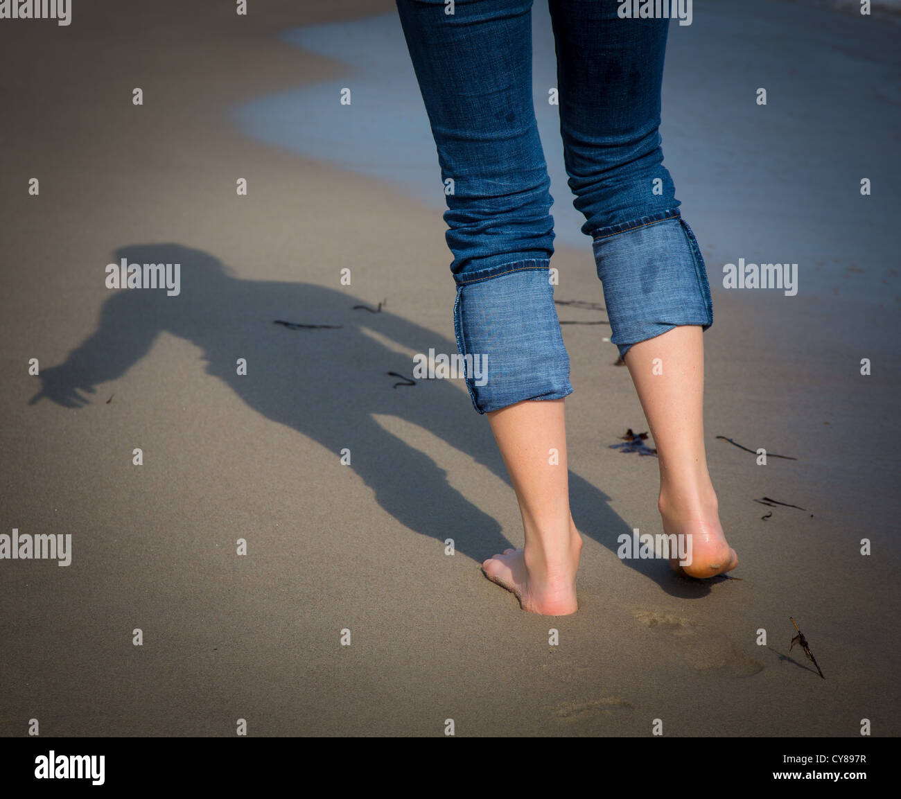 Teenage girl walking on beach near the city of Ystad in the province of ... Teenage girl walking on beach near the city of Ystad in the province of ...