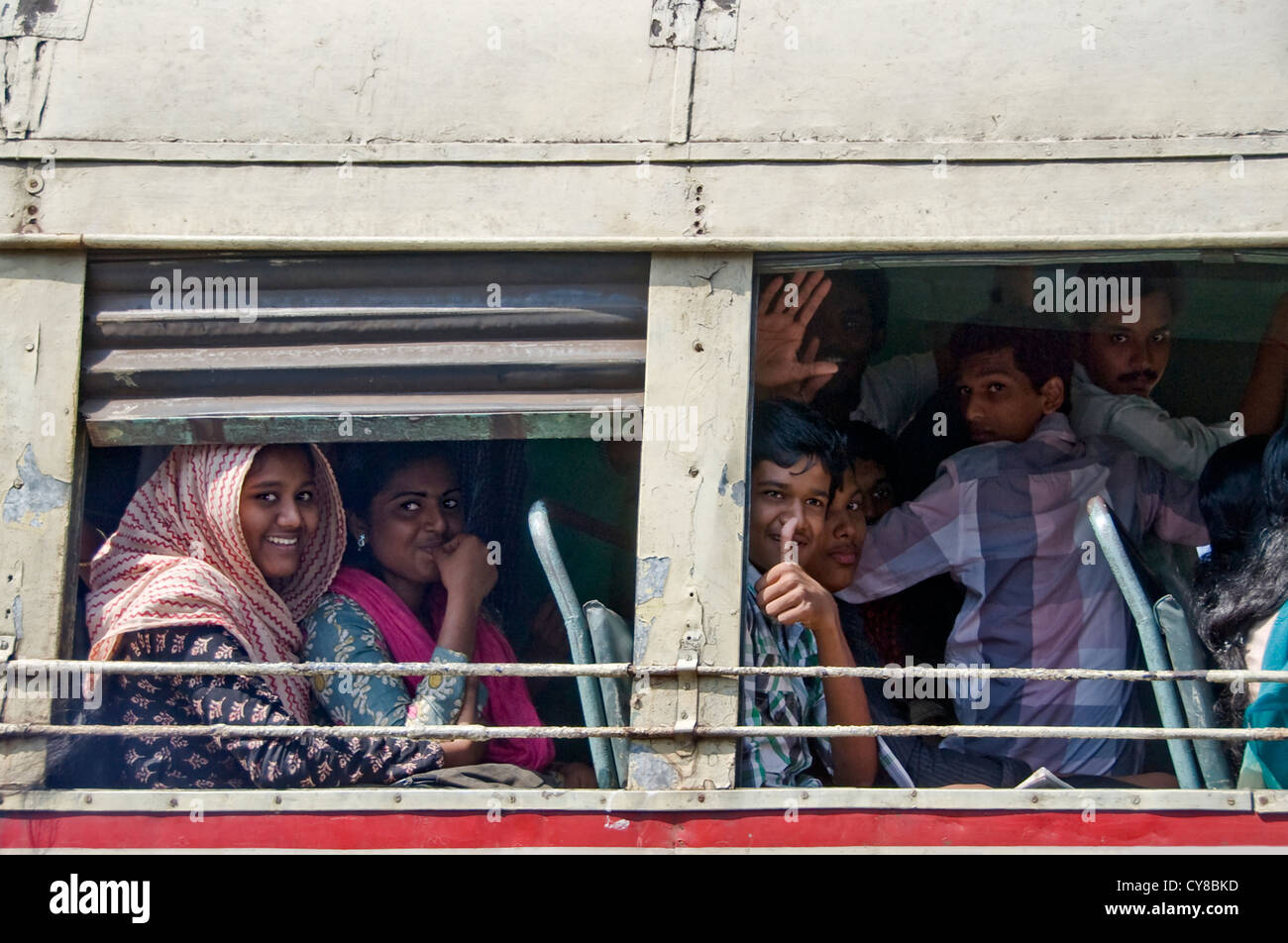 Horizontal view of a busy local bus with passengers crammed in during ...
